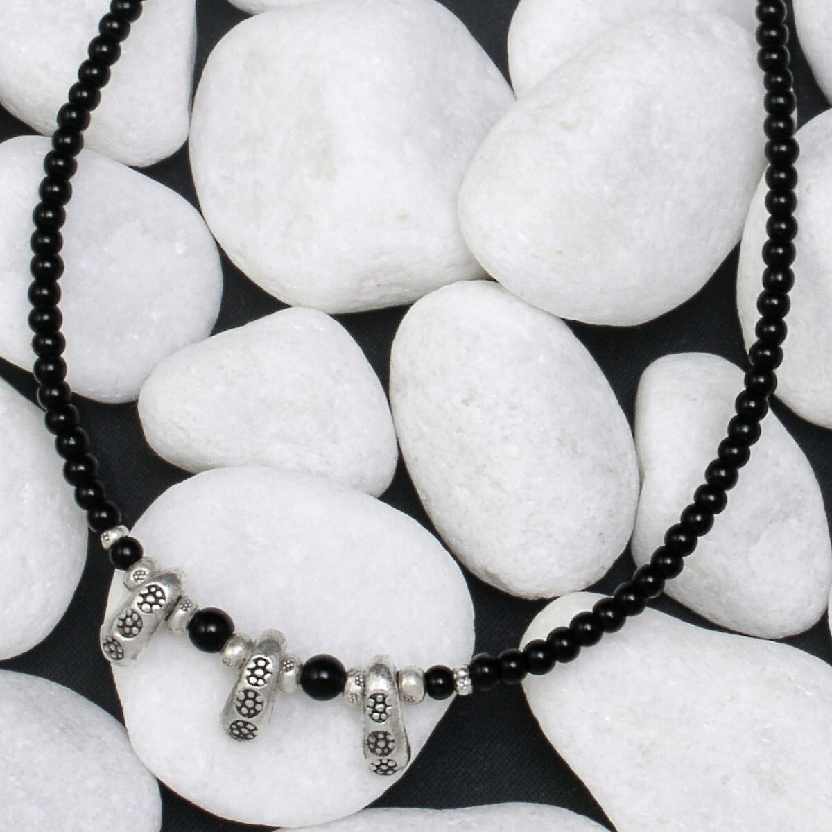 漆黒のオニキスと鈍く光る銀は心地よく調和する勾玉形シルバービーズはマンゴーがモチーフ連なる漆黒のブラックオニキスに、勾玉形のカレンシルバービーズ3個をトップに据えたネックレスです。一風変った立体的なフォルムはマンゴーがモチーフです。小粒な見...