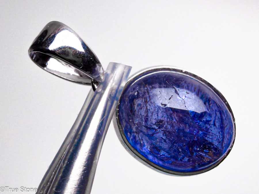 深みのある青紫色が、光の当たり方によって表情を変える一点物の天然タンザナイトペンダントトップです。 透明感のある地色の中に、天然石ならではの成長線や内部構造が見られ、人工石にはない奥行きと雰囲気をお楽しみいただけます。 カボションカットなら...