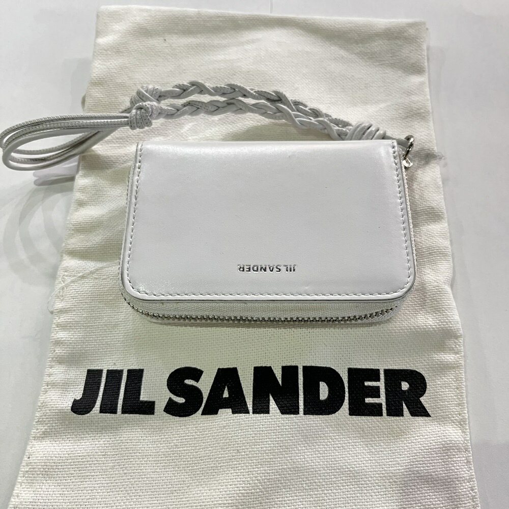 商品詳細JIL SANDER COIN CASE ジルサンダー ストラップ付 レザー コインケース ホワイト ■ブランド：JILSANDAER■品番：無し■カラー：ホワイト■状態：内側に汚れ有■付属品：袋■サイズ(約cm)：メジャー採寸の為...