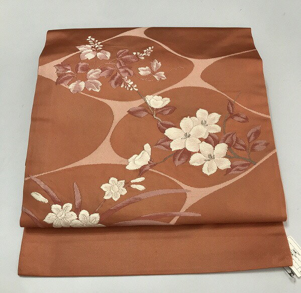 商品説明：さらりとした香色地に桐や蘭などの花々の織成しお太鼓柄九寸名古屋帯 サイズ：幅約30.5、長さ約353cm 素材：正絹 ランク4 クスミ有 TPO：普段着等 ※帯のみの販売となります