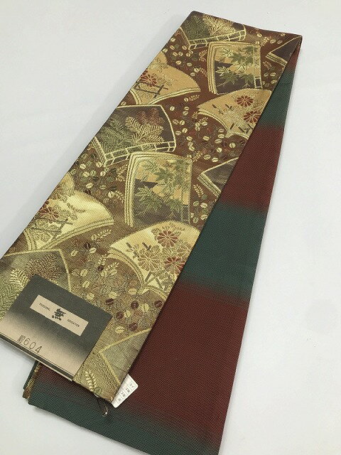 商品説明：重厚感感じる赤茶地に金糸使いの織成し サイズ：幅約16、長さ約420cm 素材：化繊 状態：ランク5 TPO：衣装 普段着等 ※帯のみの販売となります