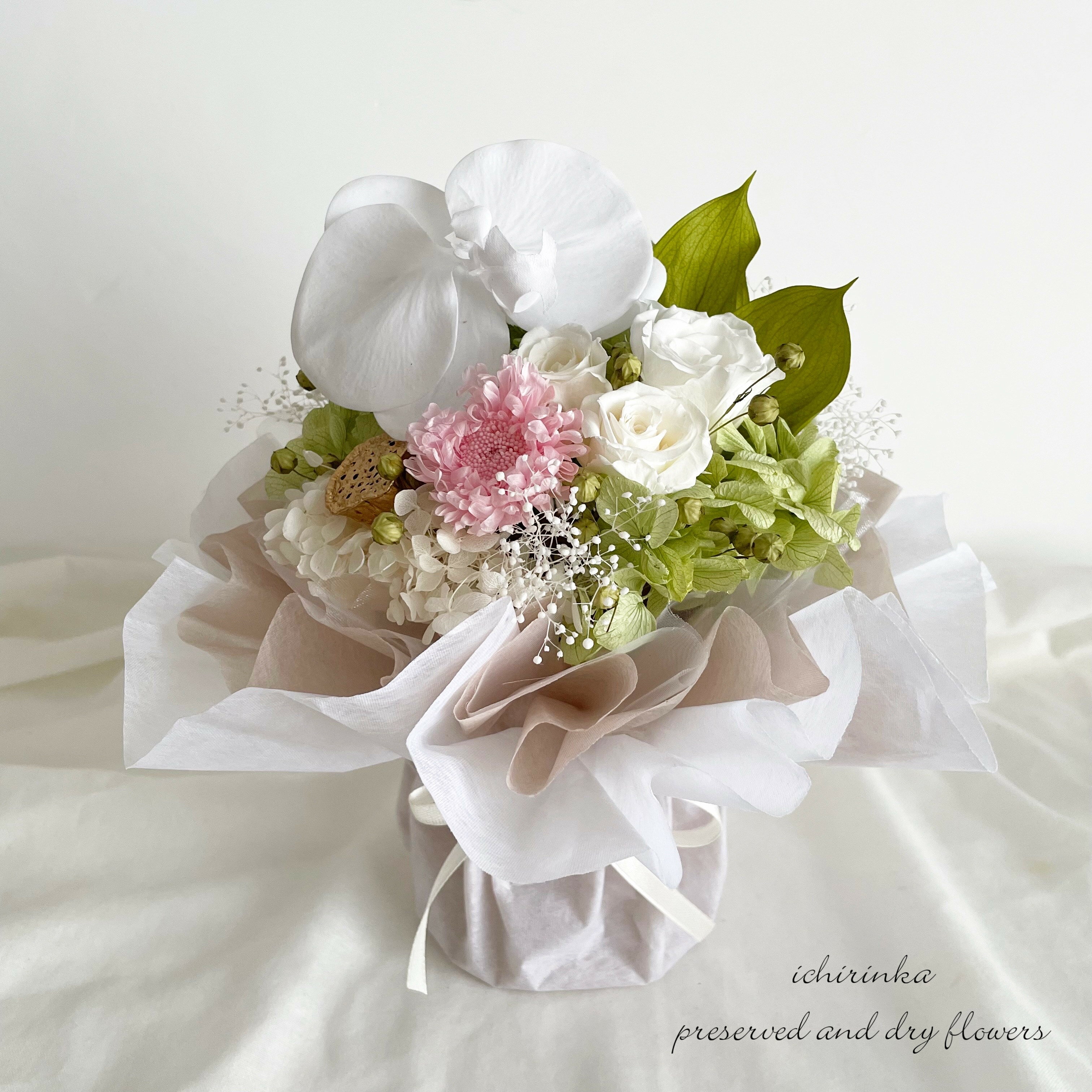 商品情報使用花材主にプリザーブドフラワー・ドライフラワーを使用。胡蝶蘭（造花）、菊(プリザ)、バラ（プリザ）、アジサイ（プリザ）、かすみ草（プリザ）など小花などは仕入れ状況により店長おまかせサイズ幅約　18cm高さ 22cm注意点ブリザード...