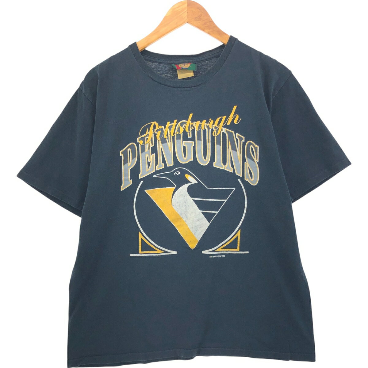 商品詳細 ブランド・JOSTENS・ 特徴・クルーネック(丸首)・半袖・ヴィンテージ・シングルステッチ・ モデル/形状・NHL PITTSBURGH PENGUINS ピッツバーグペンギンズ・ロゴプリントTシャツ・ 素材・コットン:100%...