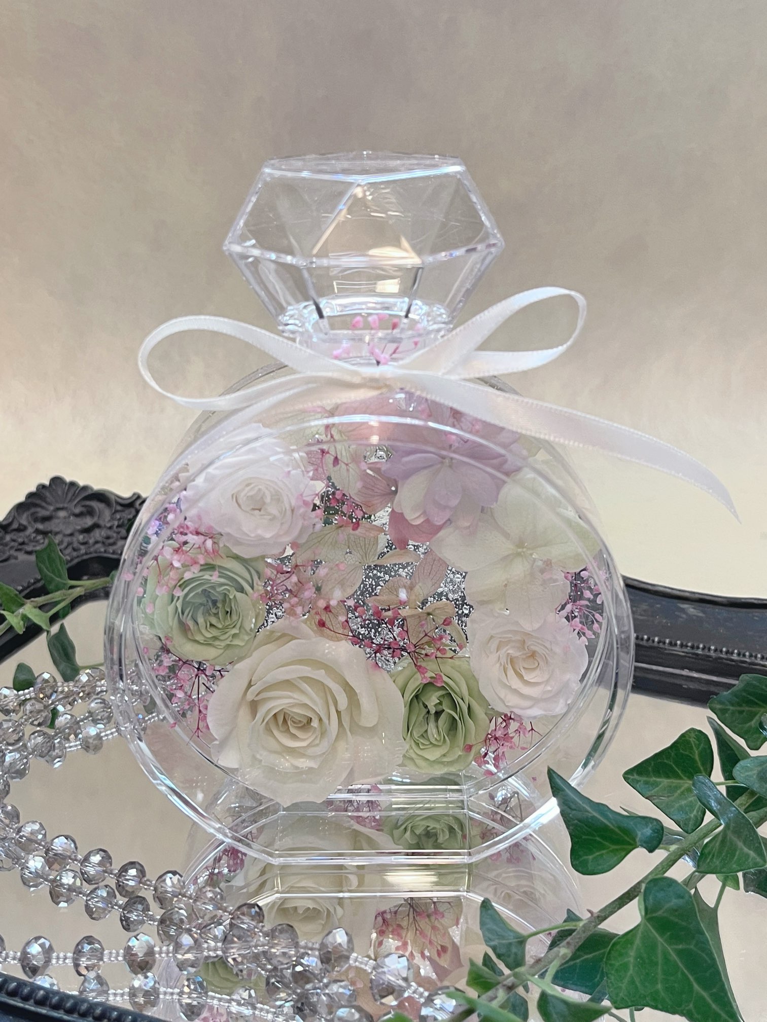 透明感抜群の香水瓶にプリザーブドフラワーを詰め込んだ、特別なギフトはいかがですか？ 淡い色合いがほっこりとした気持ちにさせてくれます。お誕生日や結婚祝い、母の日のお礼など、さまざまなシーンで喜ばれること間違いなしです。優雅なデザインがインテ...