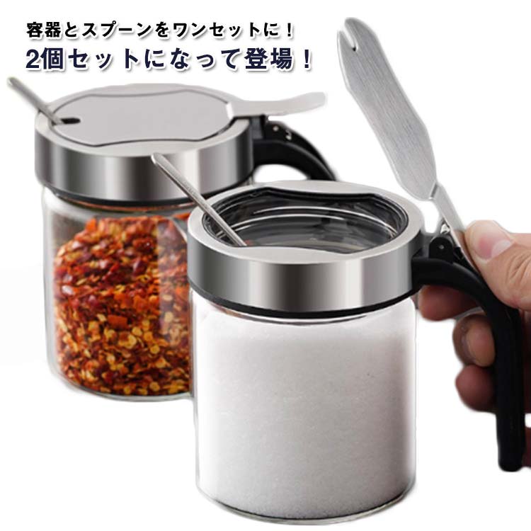 容器とスプーンをワンセットに！2個セットになって登場！手前のボタンを押すだけで簡単に蓋が開けられます。ガラス製なので、中身が見えるため、中に入れた調味料の残量を一目で確認できます。容器にステンレス製のスプーンが付いていて、すぐにすくえて便利...