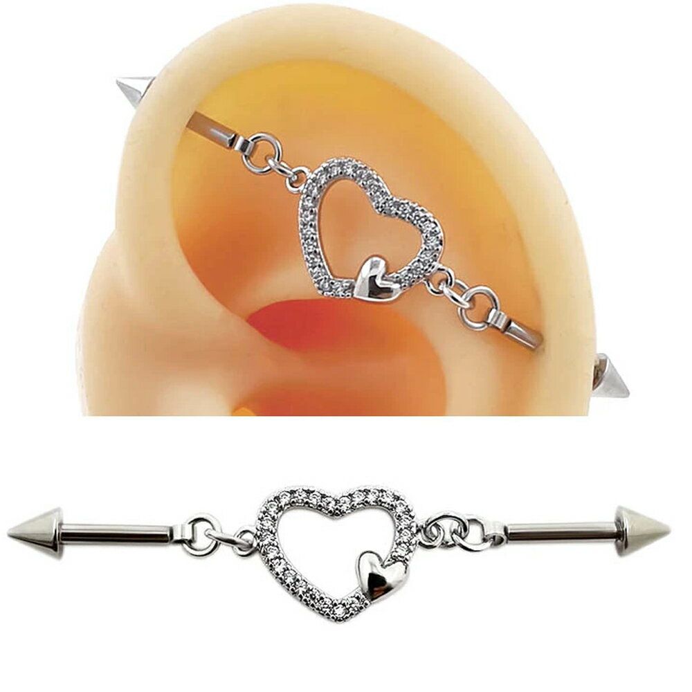 クリスタルのキュービックジルコニアをセットしたオープンハートとハートをデザインしたチャームの両側に16ゲージのストレートバーベルをセットしたピアスホールをつなぐのに便利なインダストリアル用ボディピアス。バーベルの先端はボールじゃなく円錐のコ...
