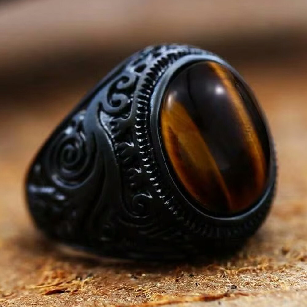 大きめの楕円形のタイガーアイの天然石を黒色の印台型のインディアンジュエリーをモチーフにしたステンレスリングのトップにセットしたボヘミアンスタイルの指輪です。 高級感のあるタイガーアイをセットした石付の指輪。 大きめのデザイン存在感を発揮して...