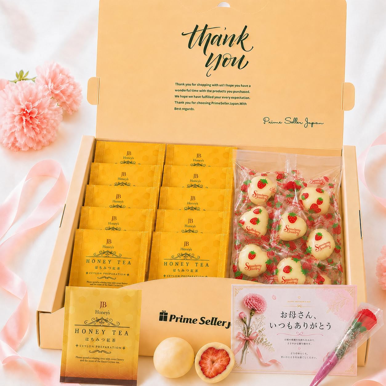 母の日の贈り物に、紅茶とお菓子を一緒に楽しめるギフトセットです。はちみつ紅茶20袋と、フリーズドライいちごのホワイトチョコレート120gを詰め合わせ、メッセージカードとミニカーネーション（造花）を添えました。届いたそのままプレゼントしやすく...