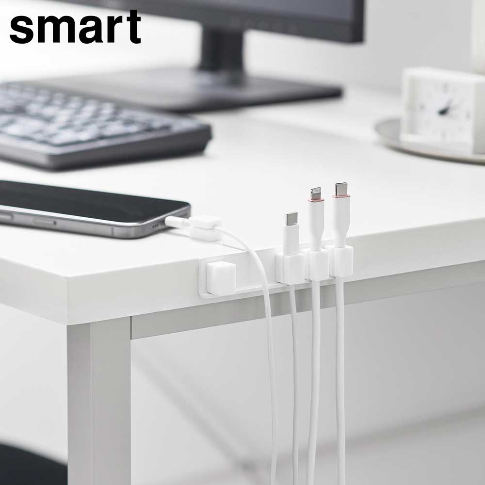 商品名称 テープで貼り付けるマグネットケーブルホルダー スマート 5連 商品スペック 商品サイズ W10×D1.4×H2cm ケーブルホルダー1つあたり：W1.1×D1.1×H1.6cm 内寸サイズ ケーブルホルダー内径1つあたり：4mm ...