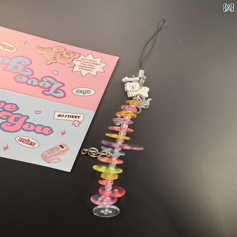 ・カテゴリ: スマホストラップ・スタイル: 男女兼用・主な素材: PVC・ストラップバックル: プラスチック・柄: カラフルボタン音符小狗